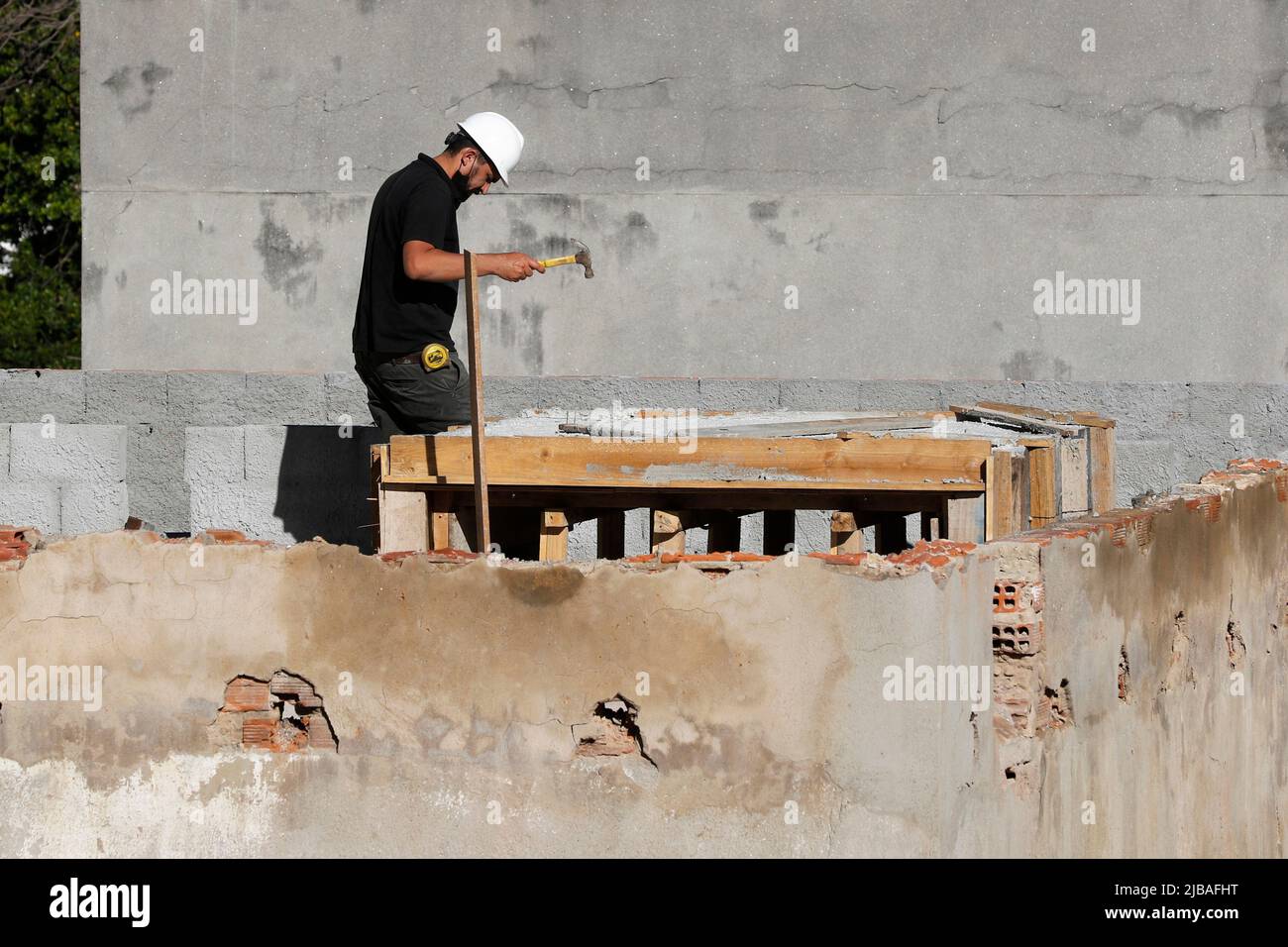 Carpenter construction worker. Workman renovating roof of building ...
