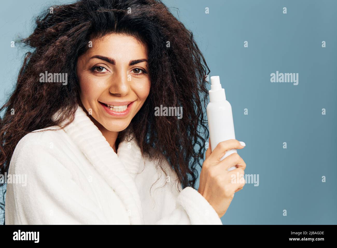 Good cosmetic ad offer. Happy pretty curly Latin lady in bathrobe hold ...