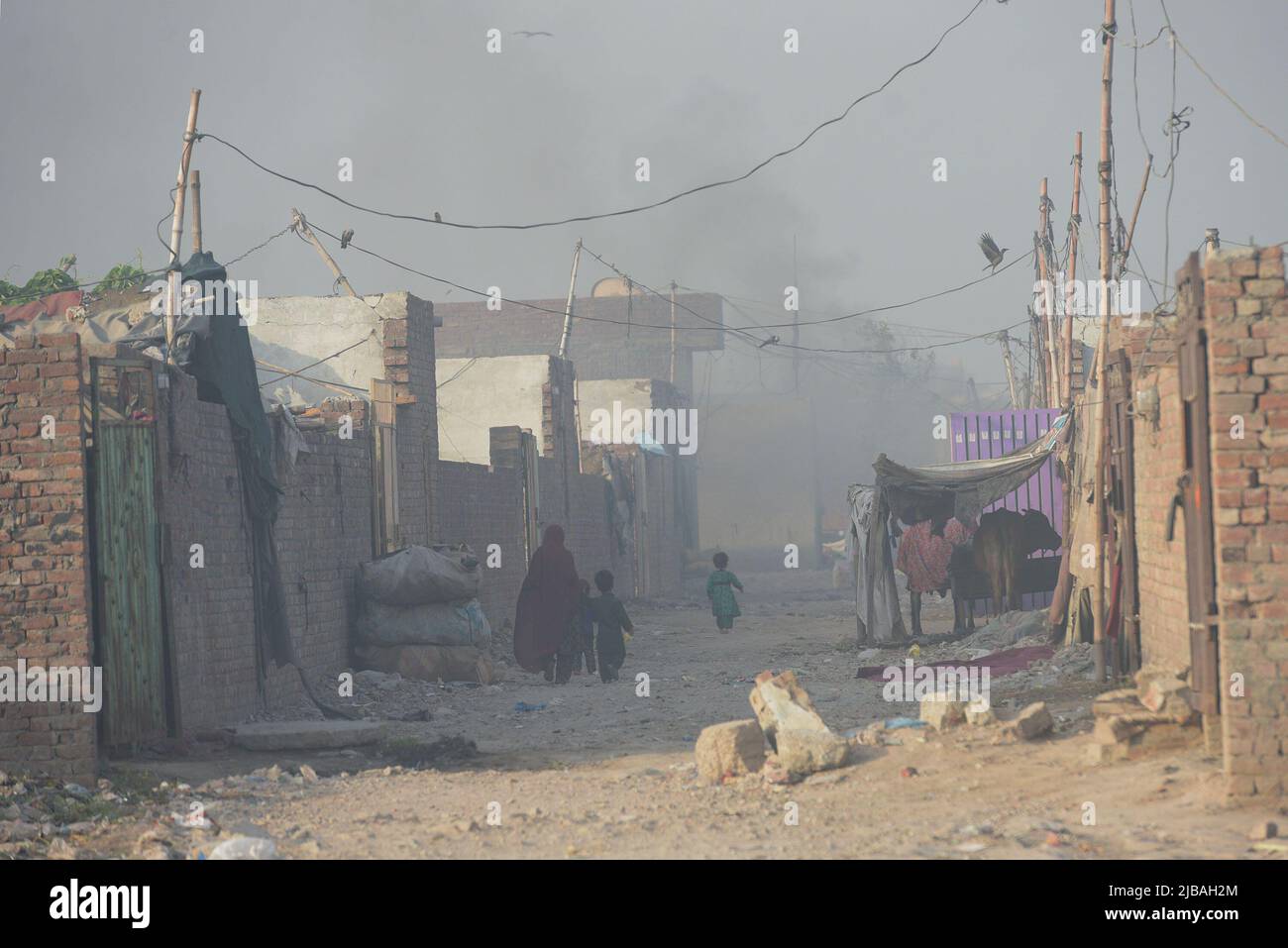 Pakistani people busy in their routine work near a garbage dump site ...