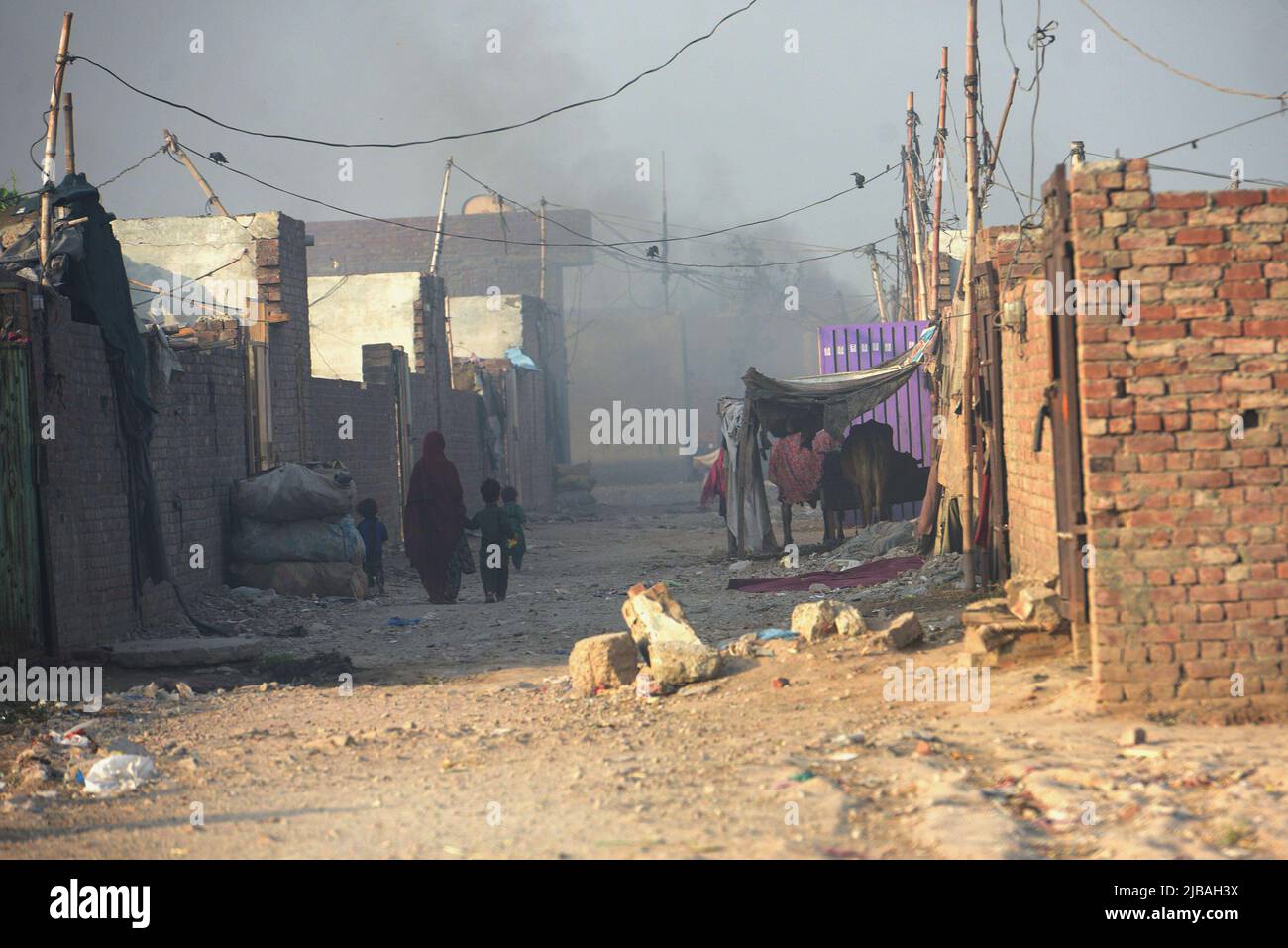 Pakistani people busy in their routine work near a garbage dump site ...