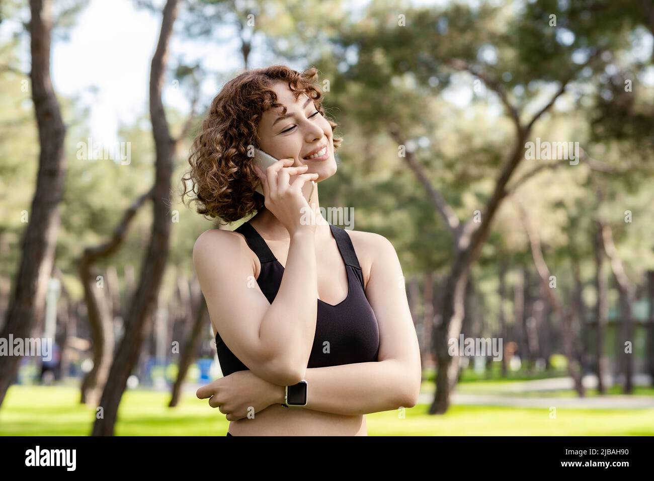 Cute caucasian woman wearing black sports bra standing on city park ...