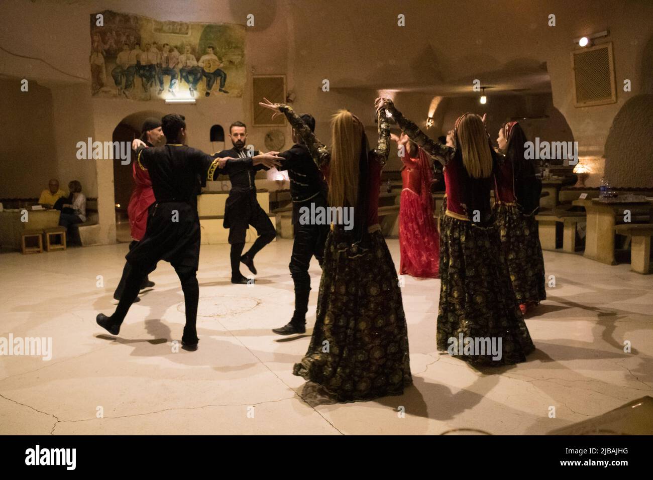 Traditional Turkish dancers dance for tourists in a local restaurant ...
