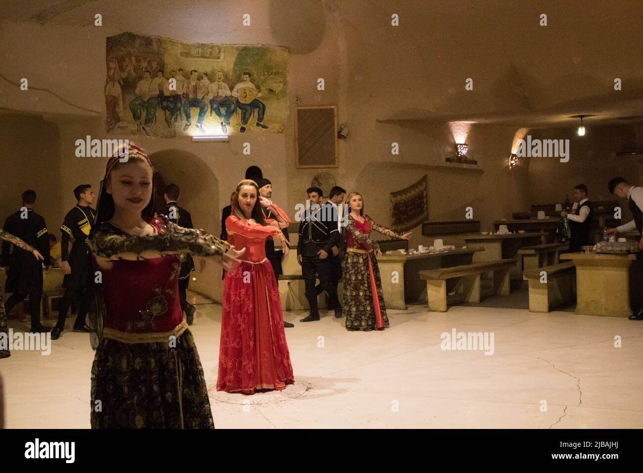 Traditional Turkish dancers dance for tourists in a local restaurant ...
