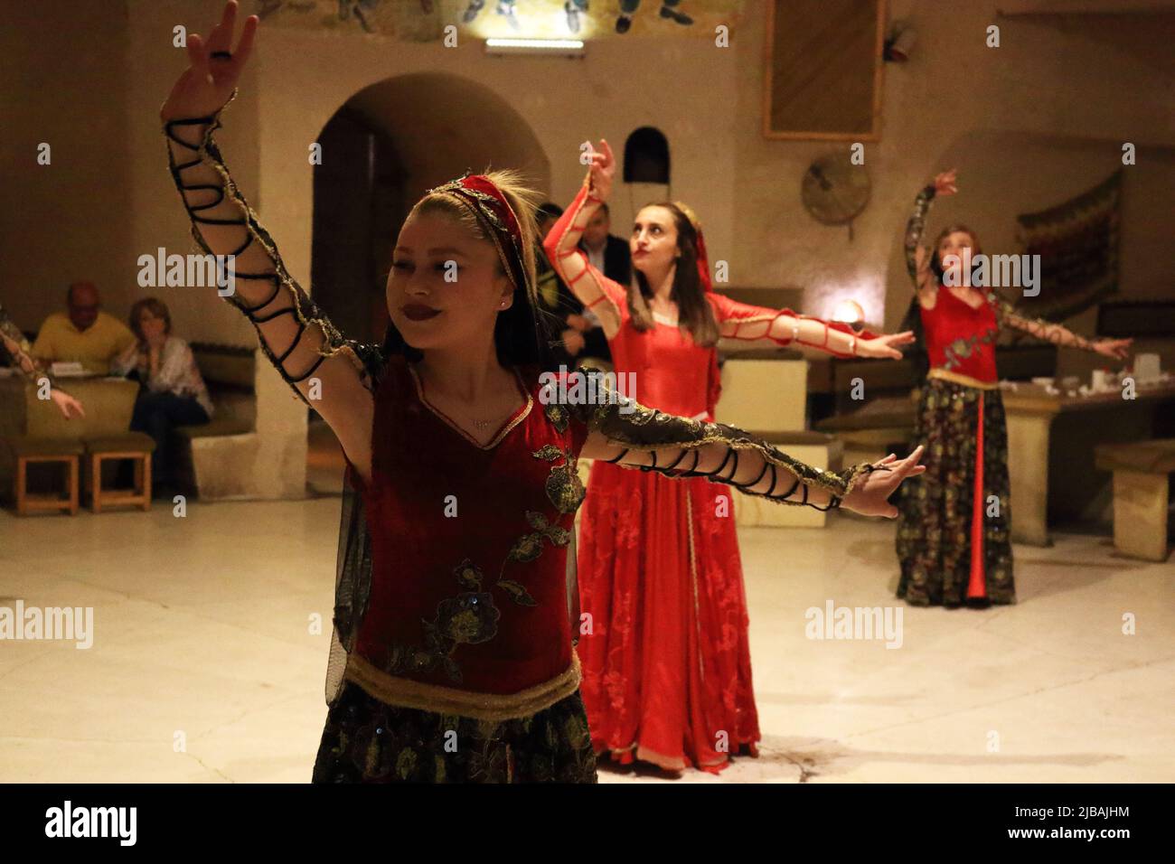 Traditional Turkish dancers dance for tourists in a local restaurant ...