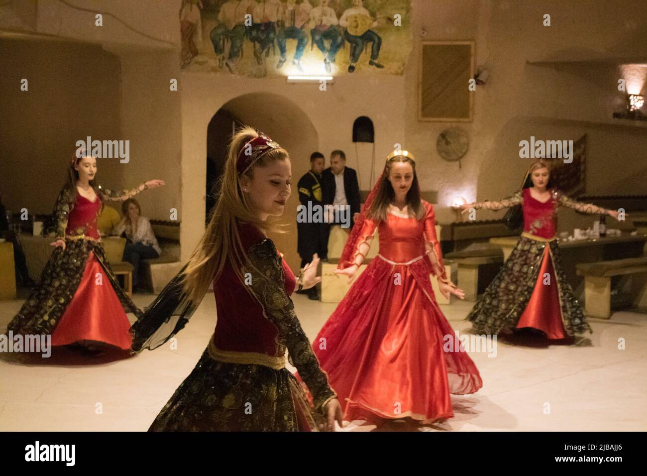 Traditional Turkish dancers dance for tourists in a local restaurant ...