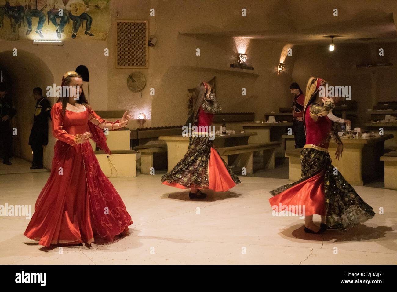Traditional Turkish dancers dance for tourists in a local restaurant ...
