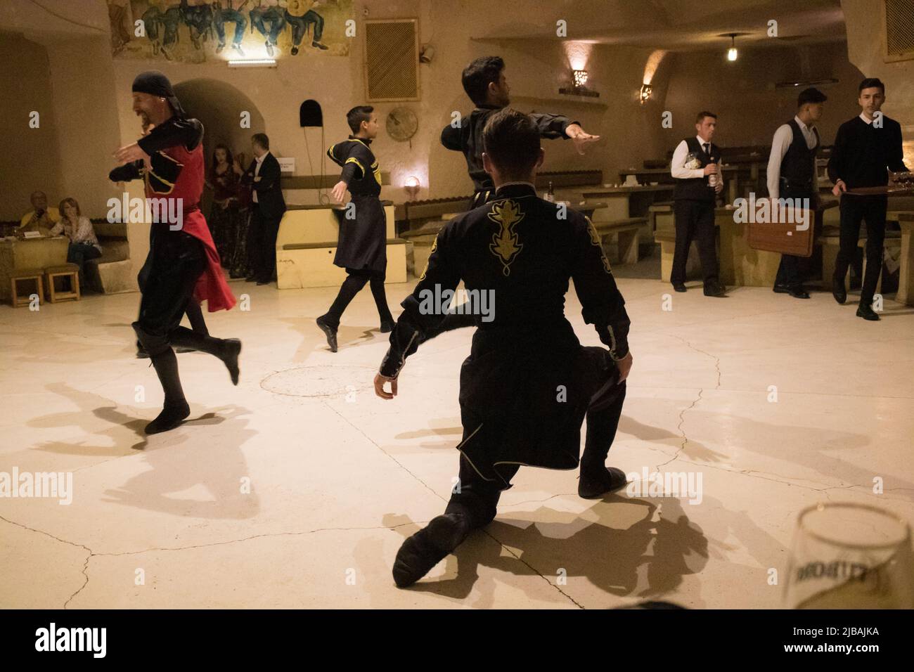 Traditional Turkish dancers dance for tourists in a local restaurant ...