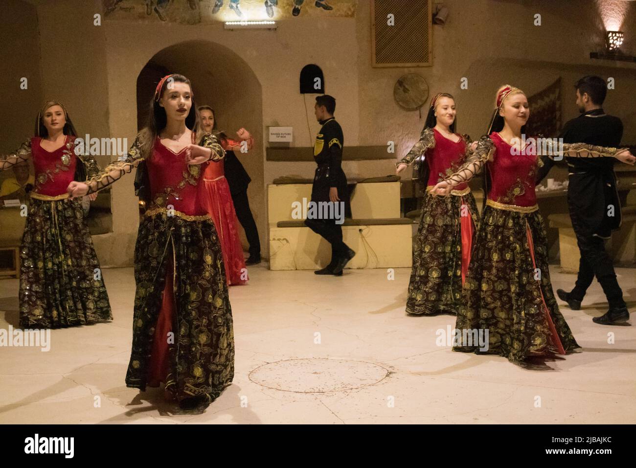 Traditional Turkish dancers dance for tourists in a local restaurant ...