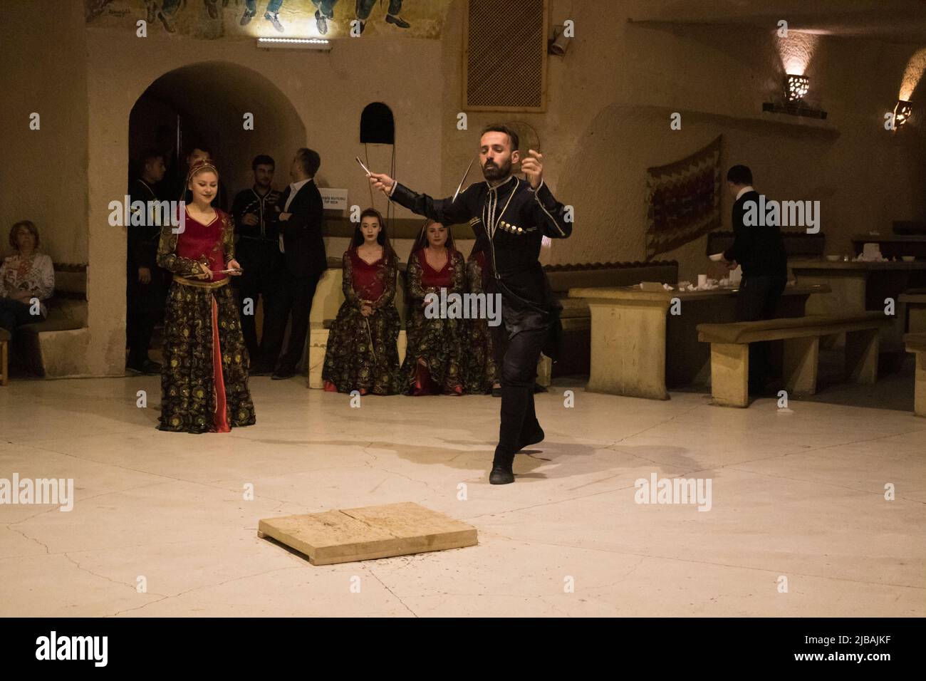 Traditional Turkish dancers dance for tourists in a local restaurant ...