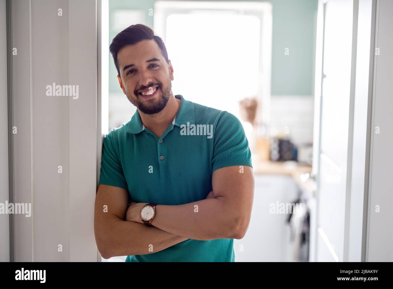 Young man in kitchen with arms crossed hi-res stock photography and ...