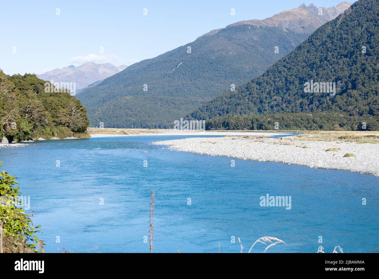 Scenic Makarora River flowing between bush-clad mountains of Southern ...