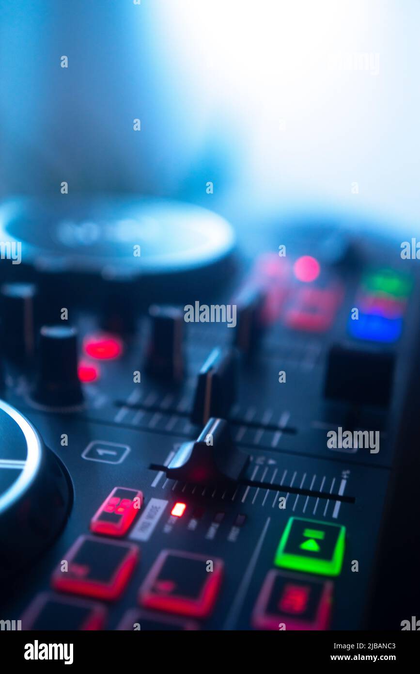 DJ mixing desk turntable in colored wedding disco party lights Stock ...