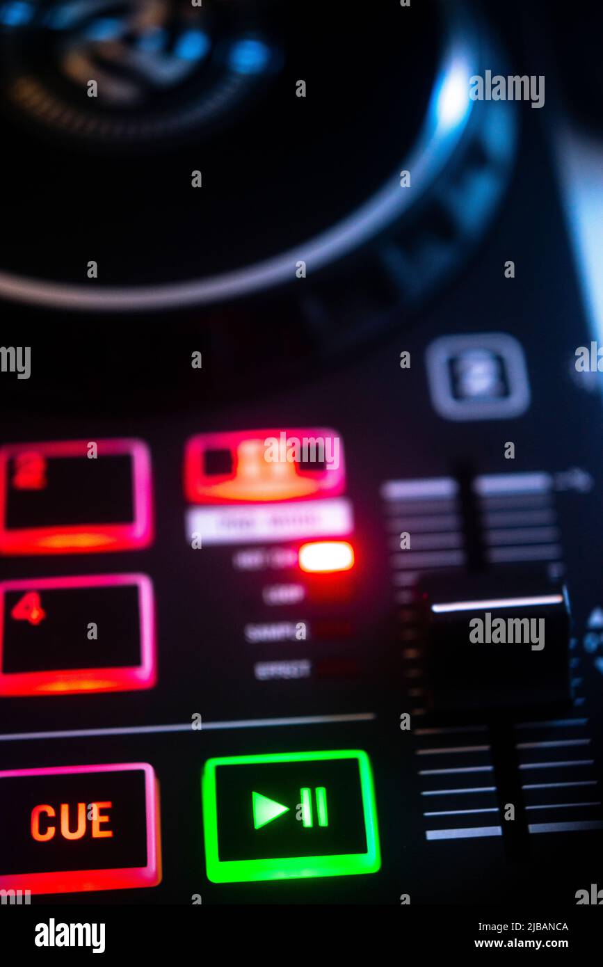 DJ mixing desk turntable in colored wedding disco party lights Stock ...