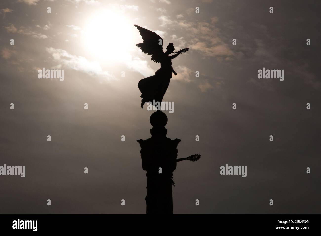 Silhouette of an ancient roman bronze angel statue on a pillar. Angels ...