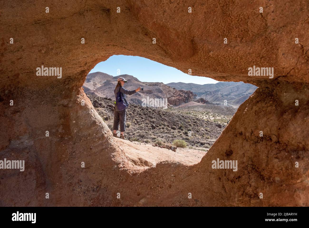 View from Window Rock framing female teen hiker taking photo with phone ...
