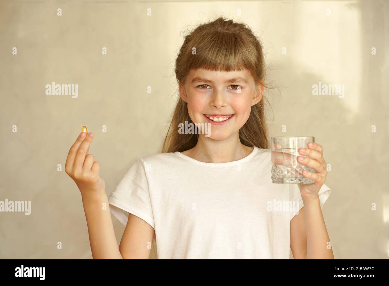 Oily fish. Little girl takes fish oil Stock Photo - Alamy