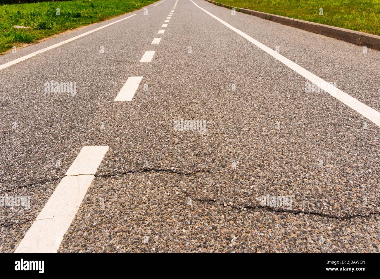 an empty city bike path along a city street in summer Stock Photo - Alamy