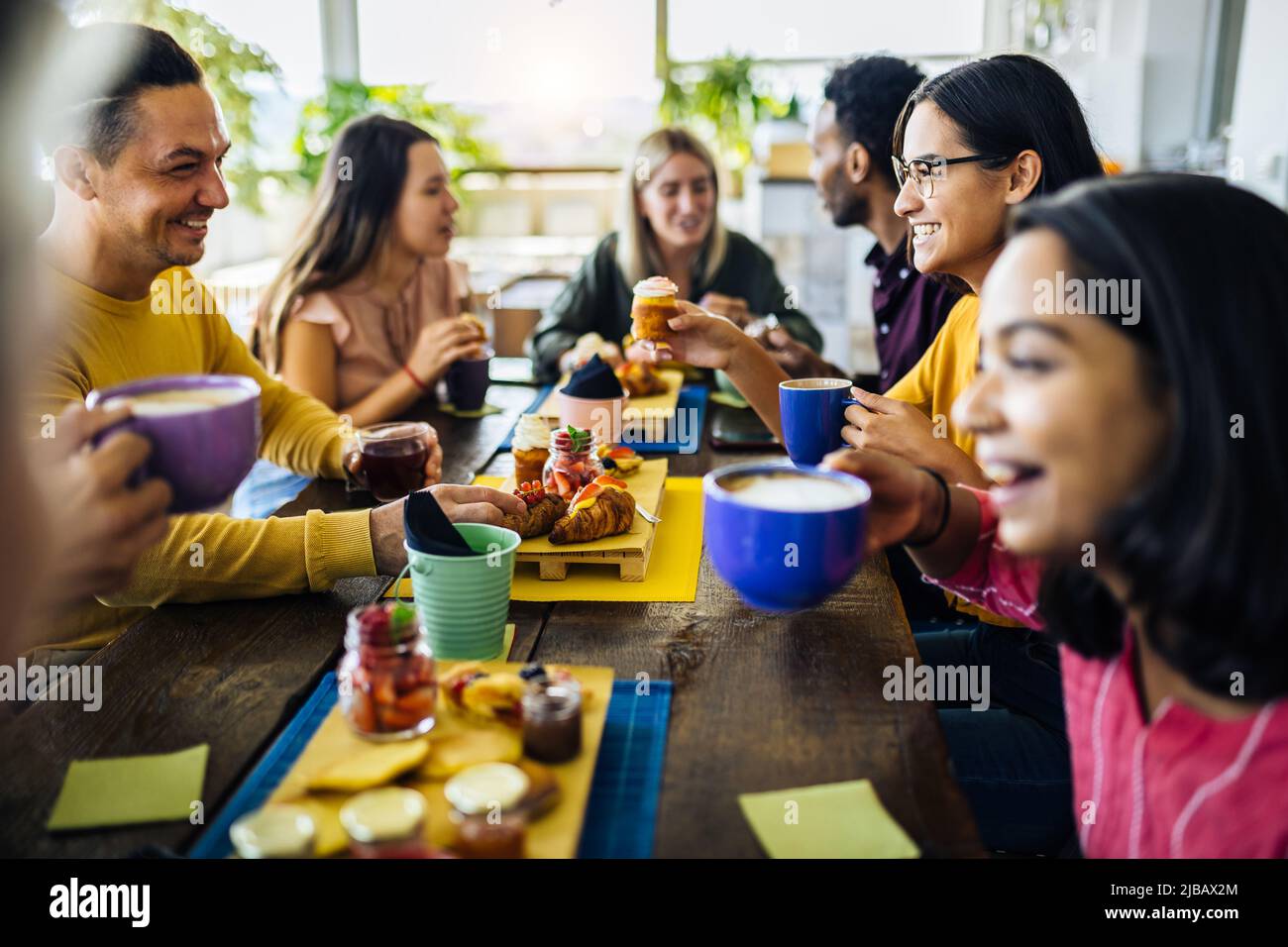 Happy group of multiracial friends having breakfast together Stock ...