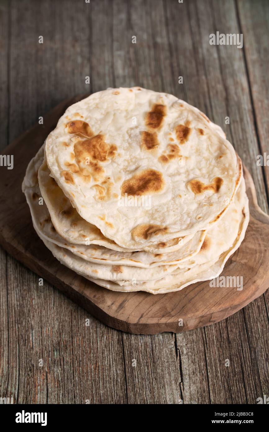 Indian chapati flatbread on the wooden table Stock Photo - Alamy