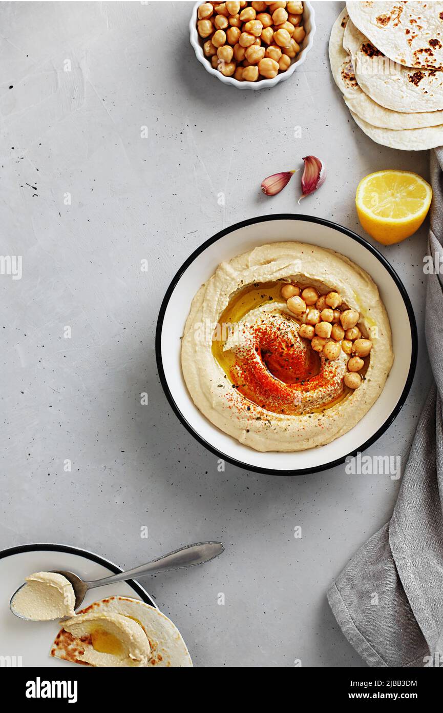Traditional oriental hummus on a gray table with flatbread, top view ...
