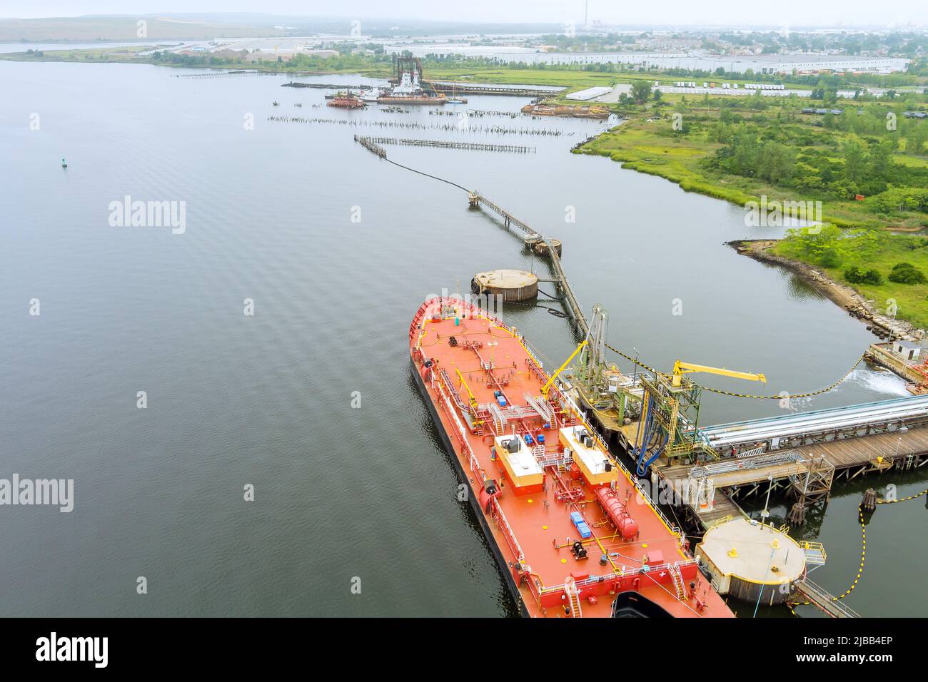Aerial view of oil rig platform in the harbor with oil tanker is ...
