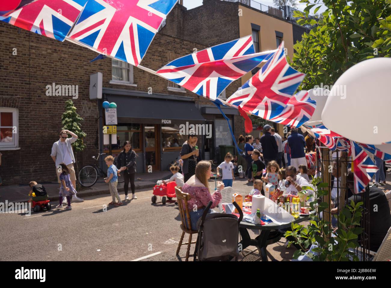 Neighbours at a community street party to commemorate Queen Elizabeth ...