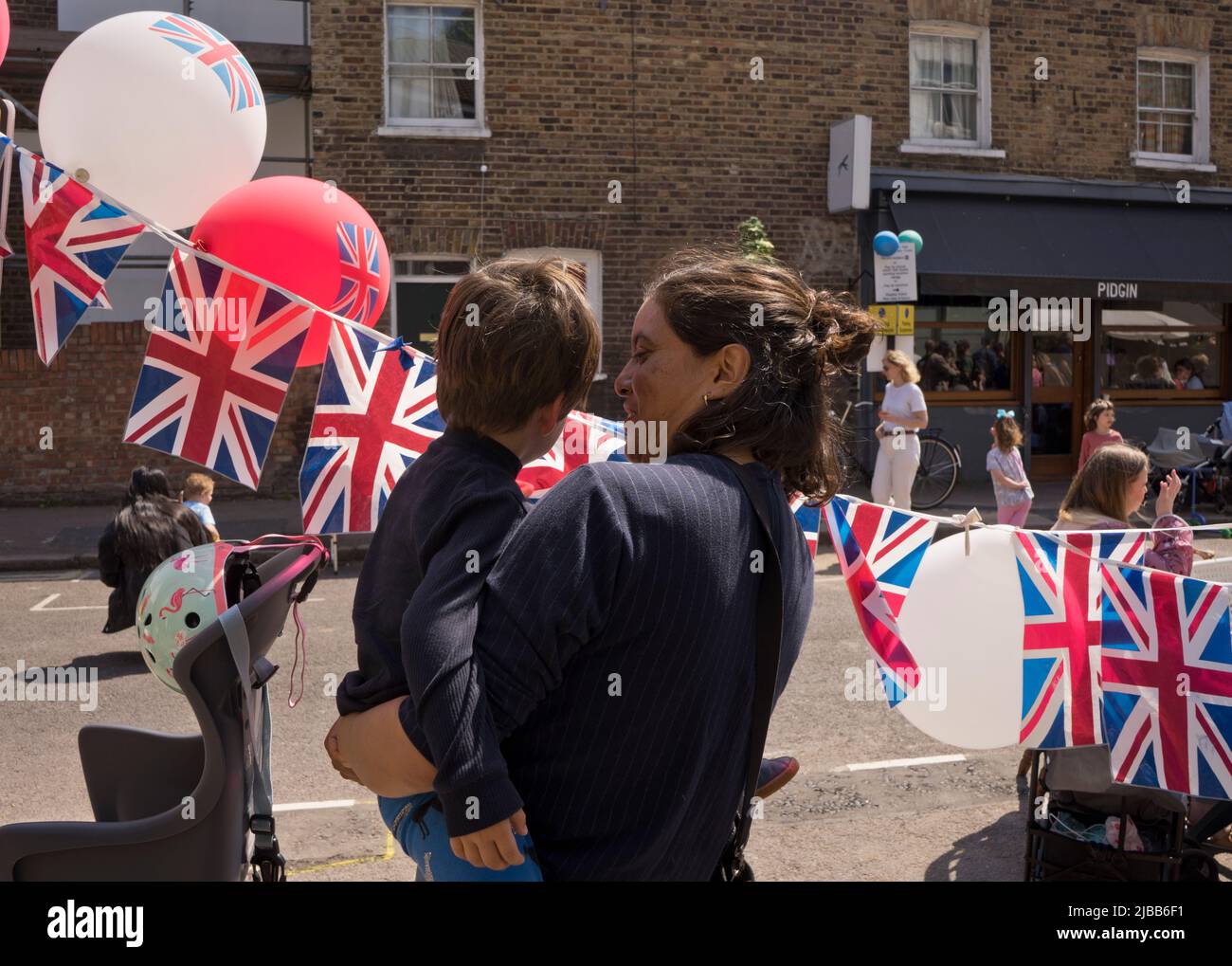 Neighbours at a community street party to commemorate Queen Elizabeth ...