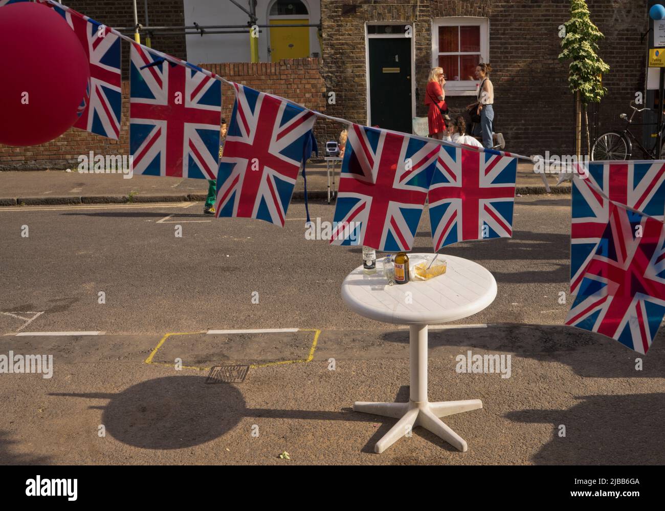 Neighbours at a community street party to commemorate Queen Elizabeth ...