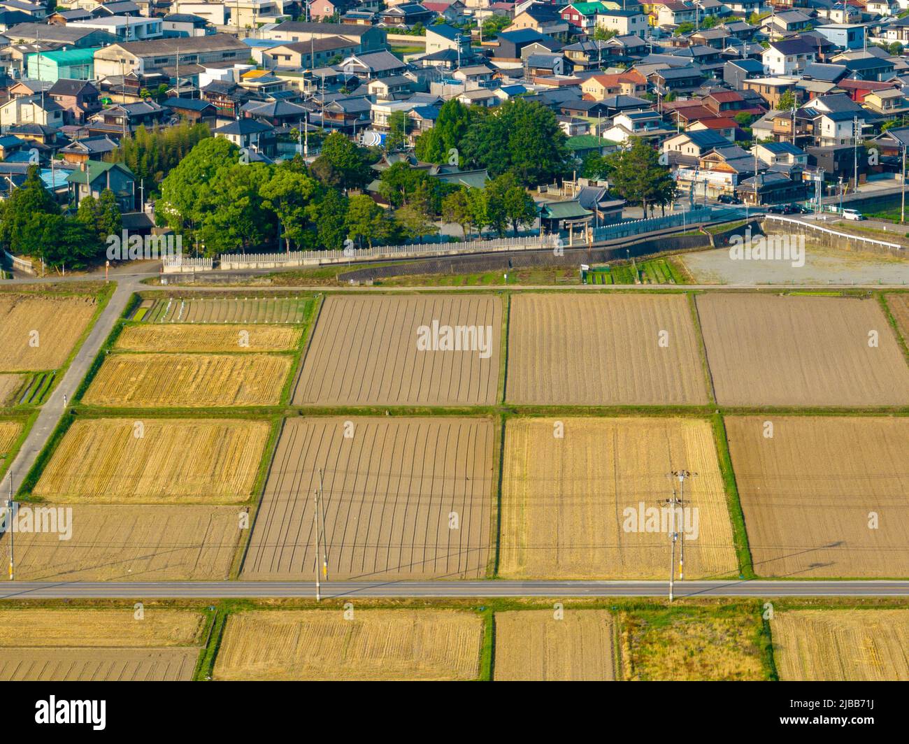 Aerial view of empty road through dry farmland on edge of town Stock ...
