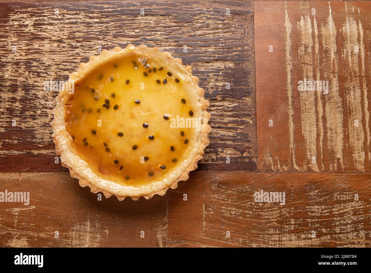 Homemade passion fruit pie with and a golden crust, on wooden ...