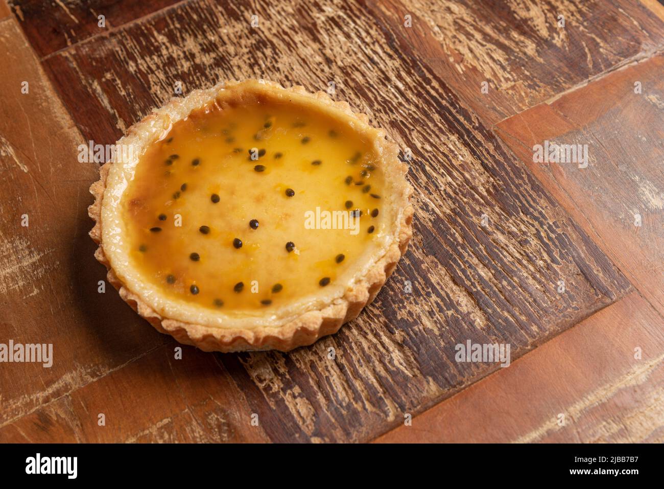Homemade passion fruit pie with and a golden crust, on wooden ...