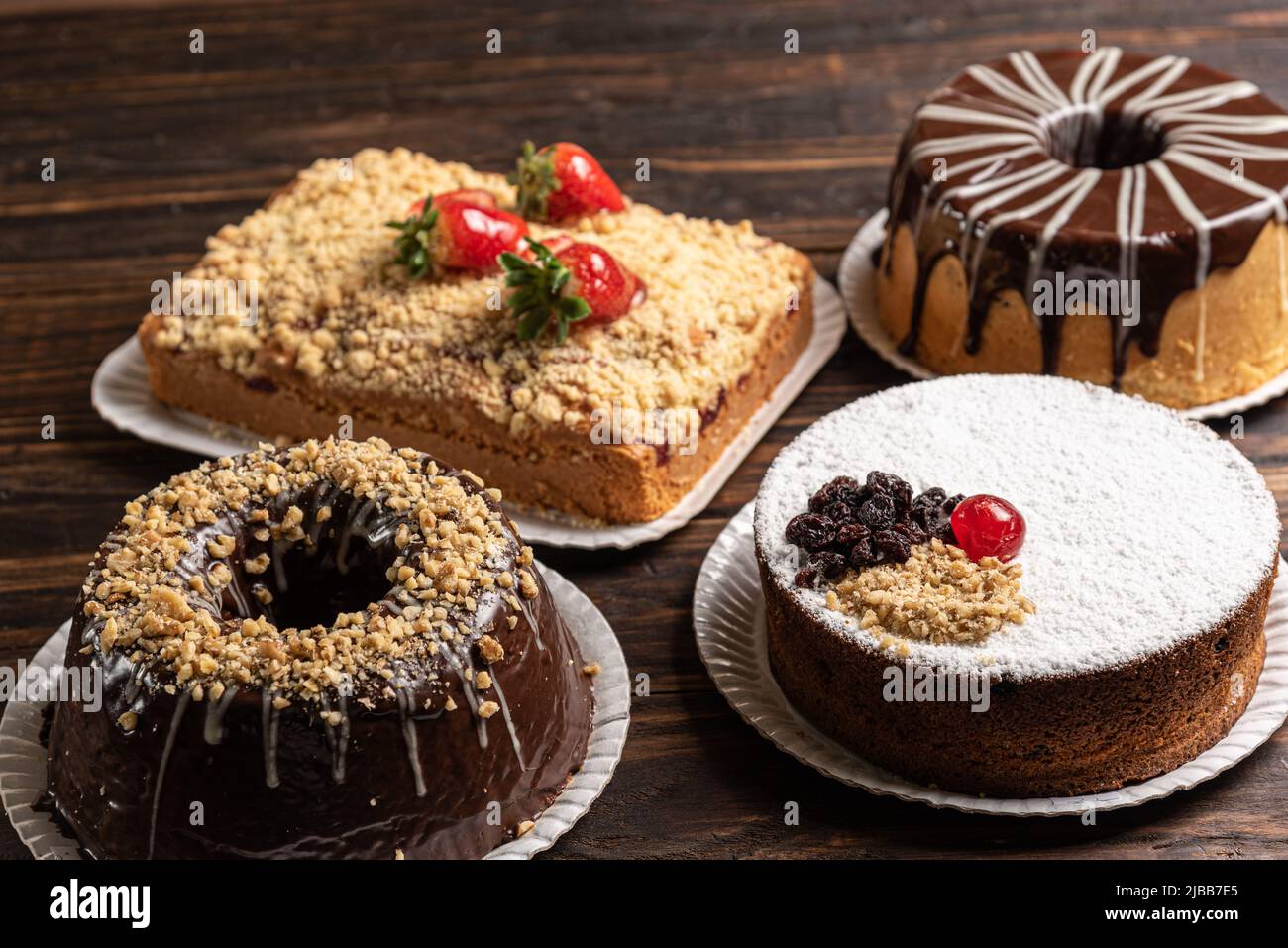 Various cakes on wooden background or table. Assortment of cakes for ...
