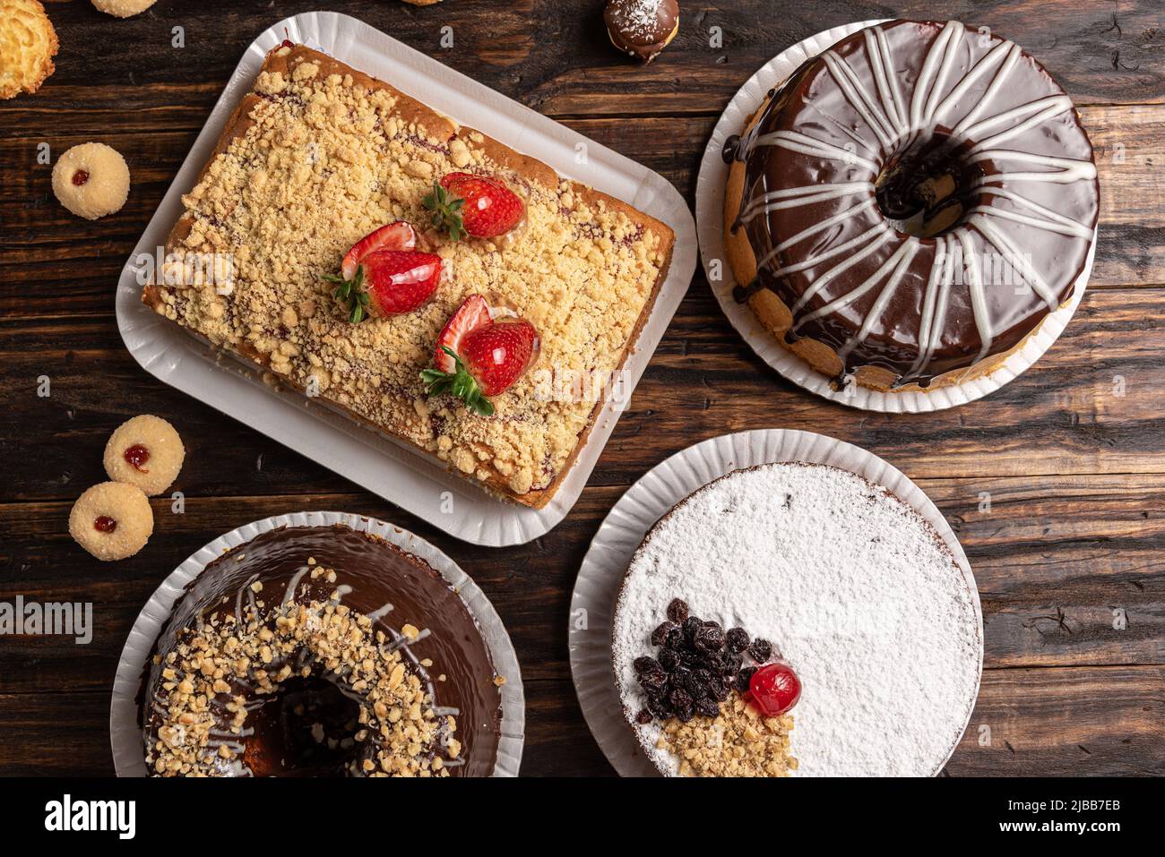 Various cakes on wooden background or table. Assortment of cakes for ...