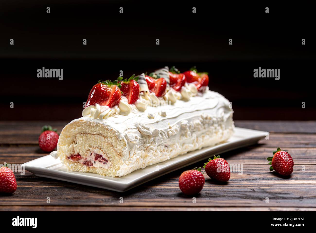 A delicious Swiss roll on woodden background. Sponge roll cake ...