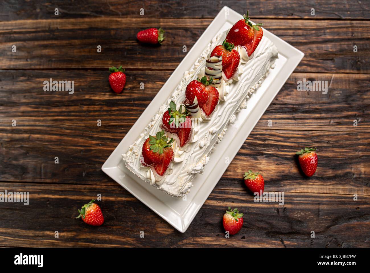 A delicious Swiss roll on woodden background. Sponge roll cake ...