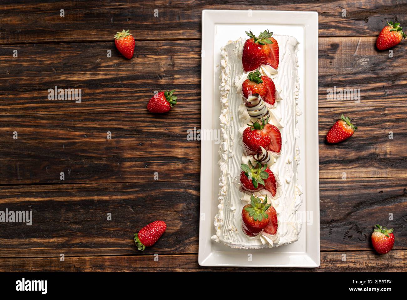 A delicious Swiss roll on woodden background. Sponge roll cake ...