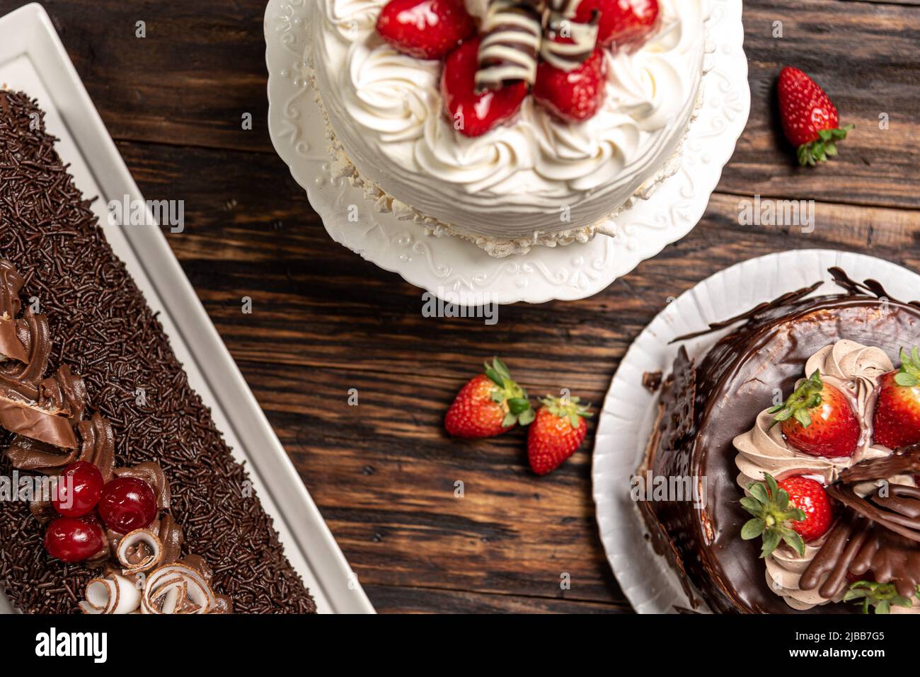 Various cakes on wooden background or table. Assortment of cakes for ...