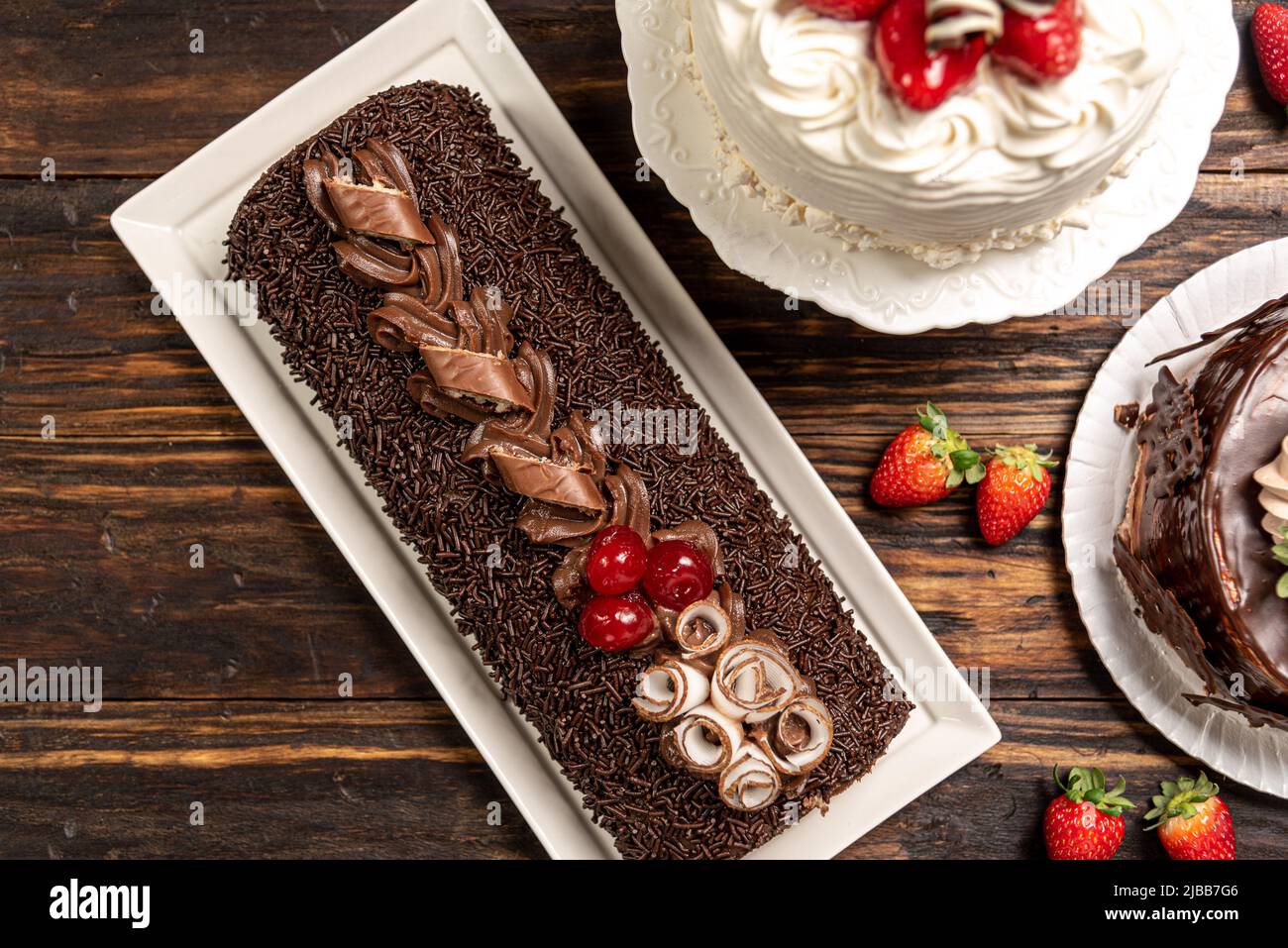 Various cakes on wooden background or table. Assortment of cakes for ...