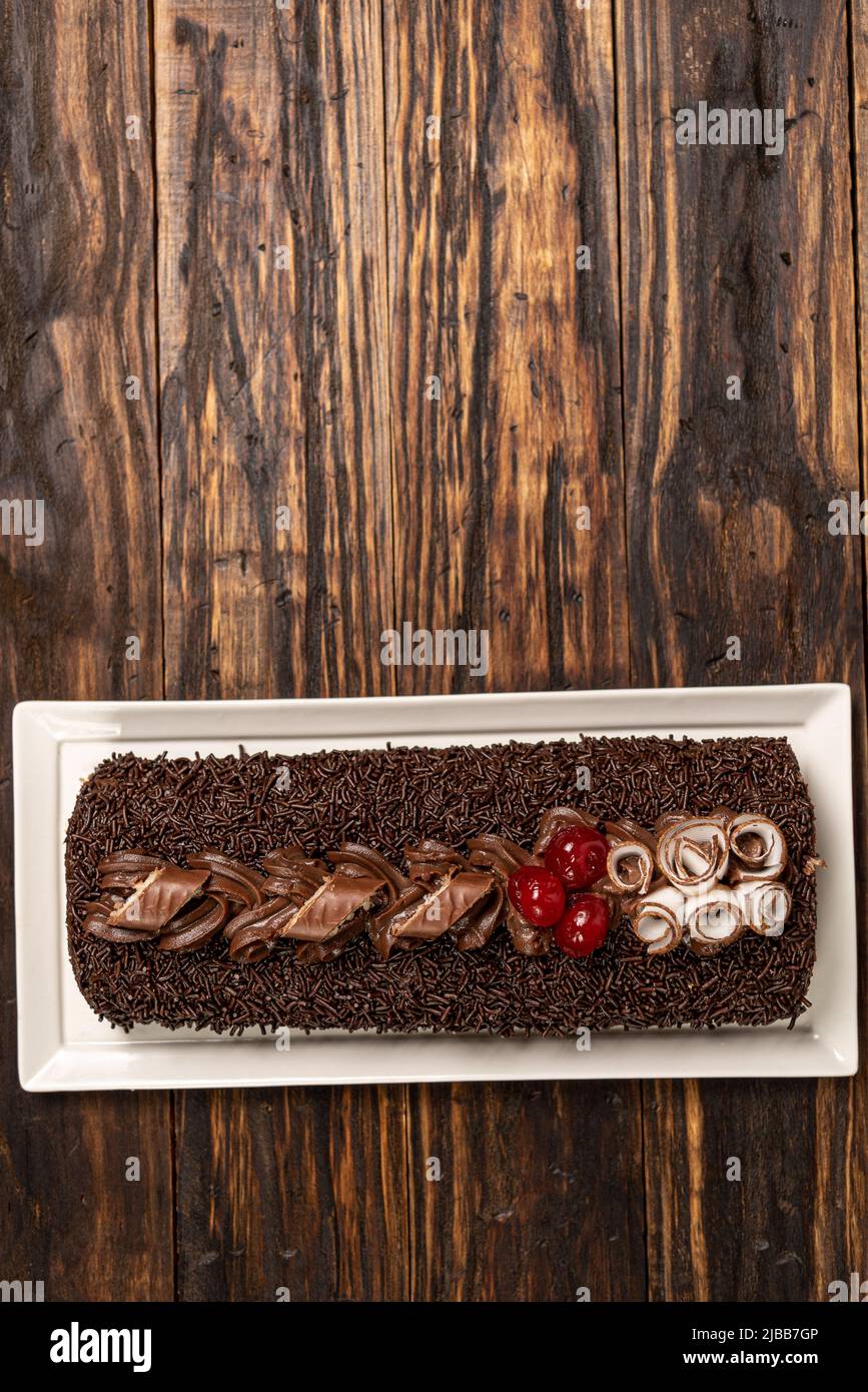 A delicious Swiss roll on woodden background. Sponge roll cake ...
