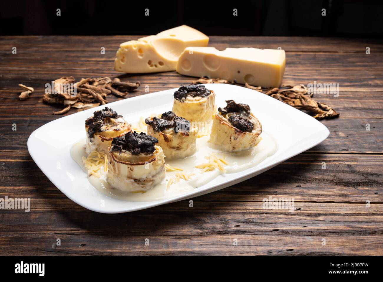Homemade rondelli with four cheese and mushuroom sauce in white plate ...