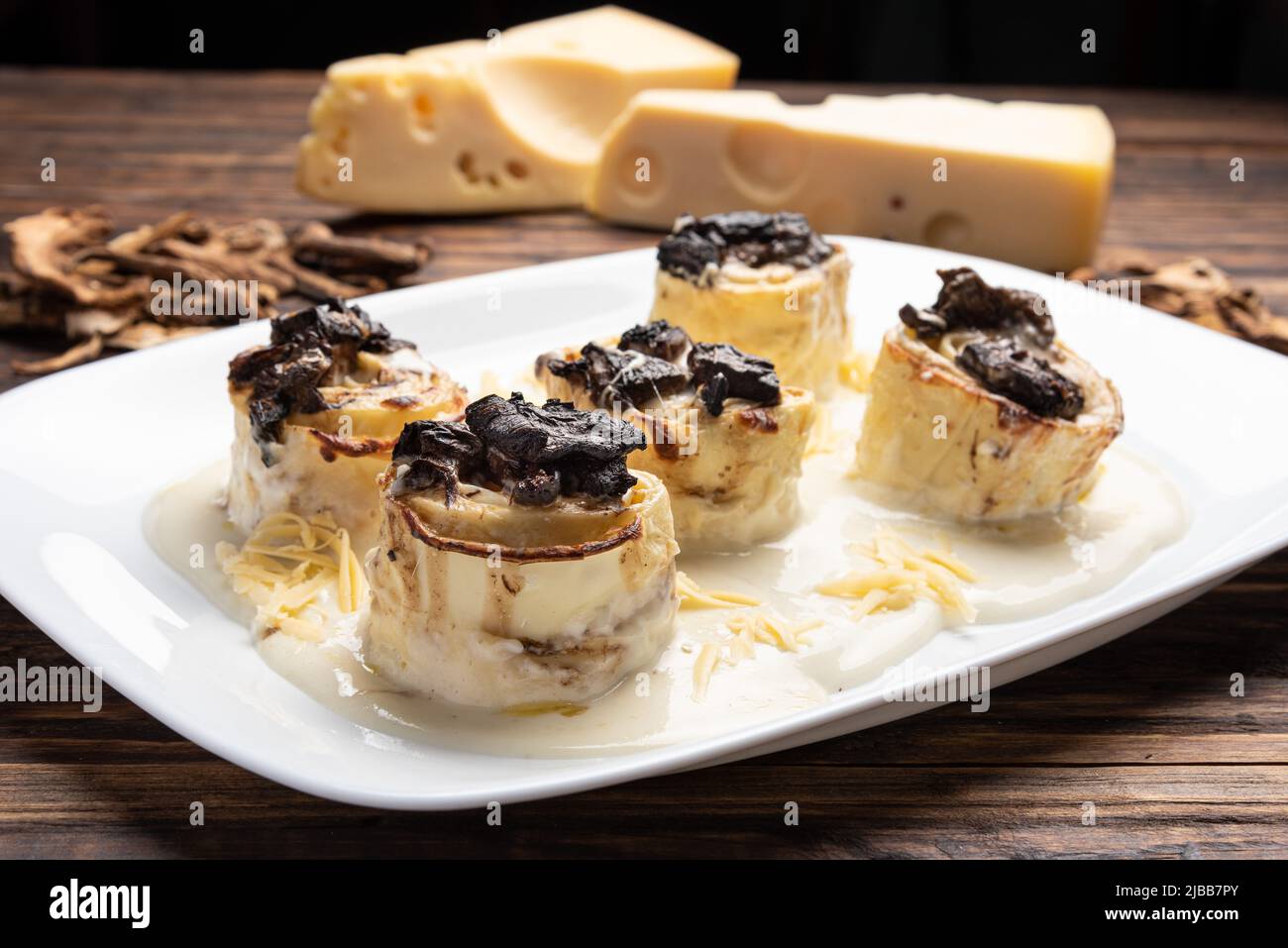 Homemade rondelli with four cheese and mushuroom sauce in white plate ...