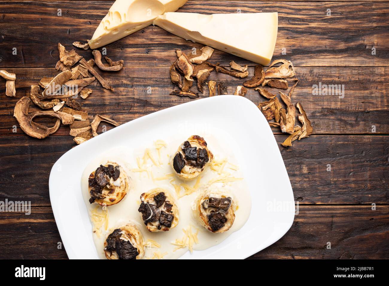 Homemade rondelli with four cheese and mushuroom sauce in white plate ...