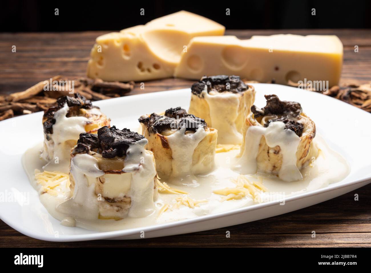 Homemade rondelli with four cheese and mushuroom sauce in white plate ...