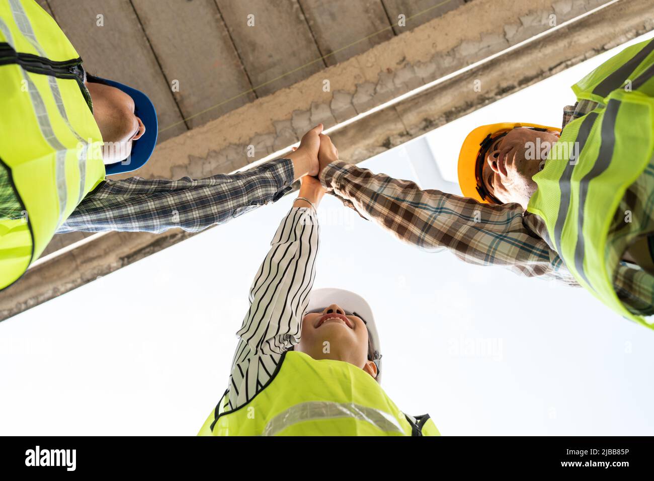 Engineer team and contractor raise their hands up together for joining ...