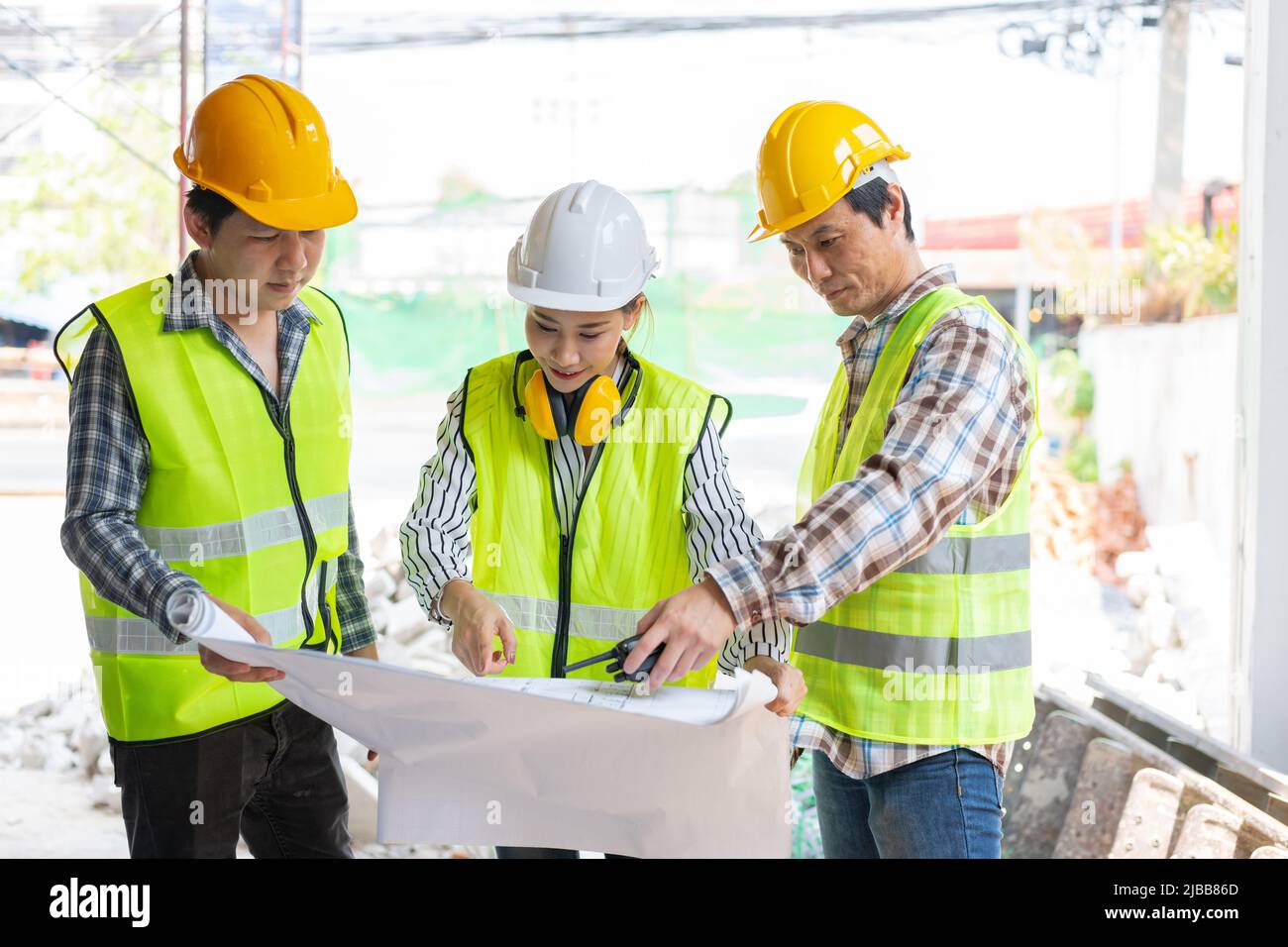 Asian engineer or Young Female Architect put on a helmet for safety and ...