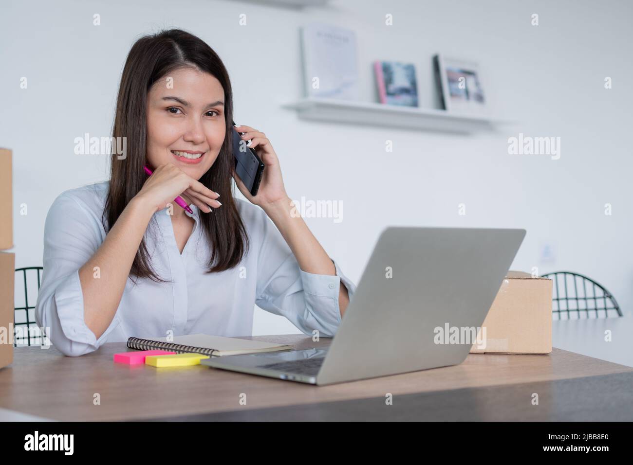 Happy young Asian woman entrepreneur, talk with a supplier and Smile ...