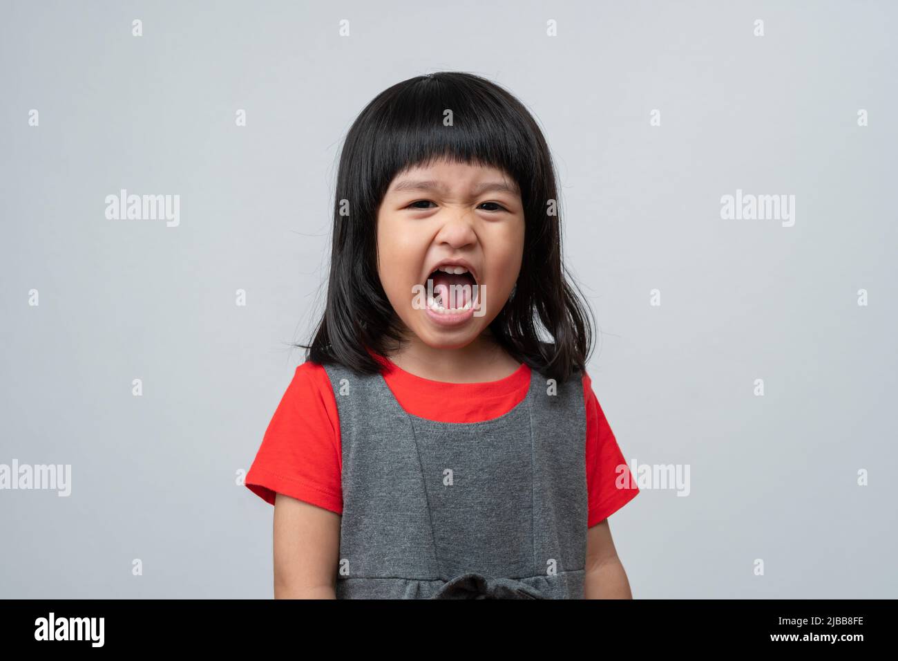 Portrait of angry emotional Asian girl screaming and frustrated ...