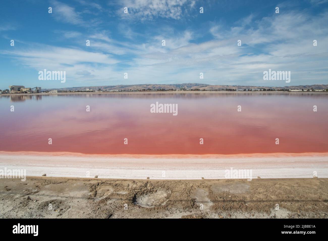 The beautiful landscape featuring water in salt ponds taking on a pink ...