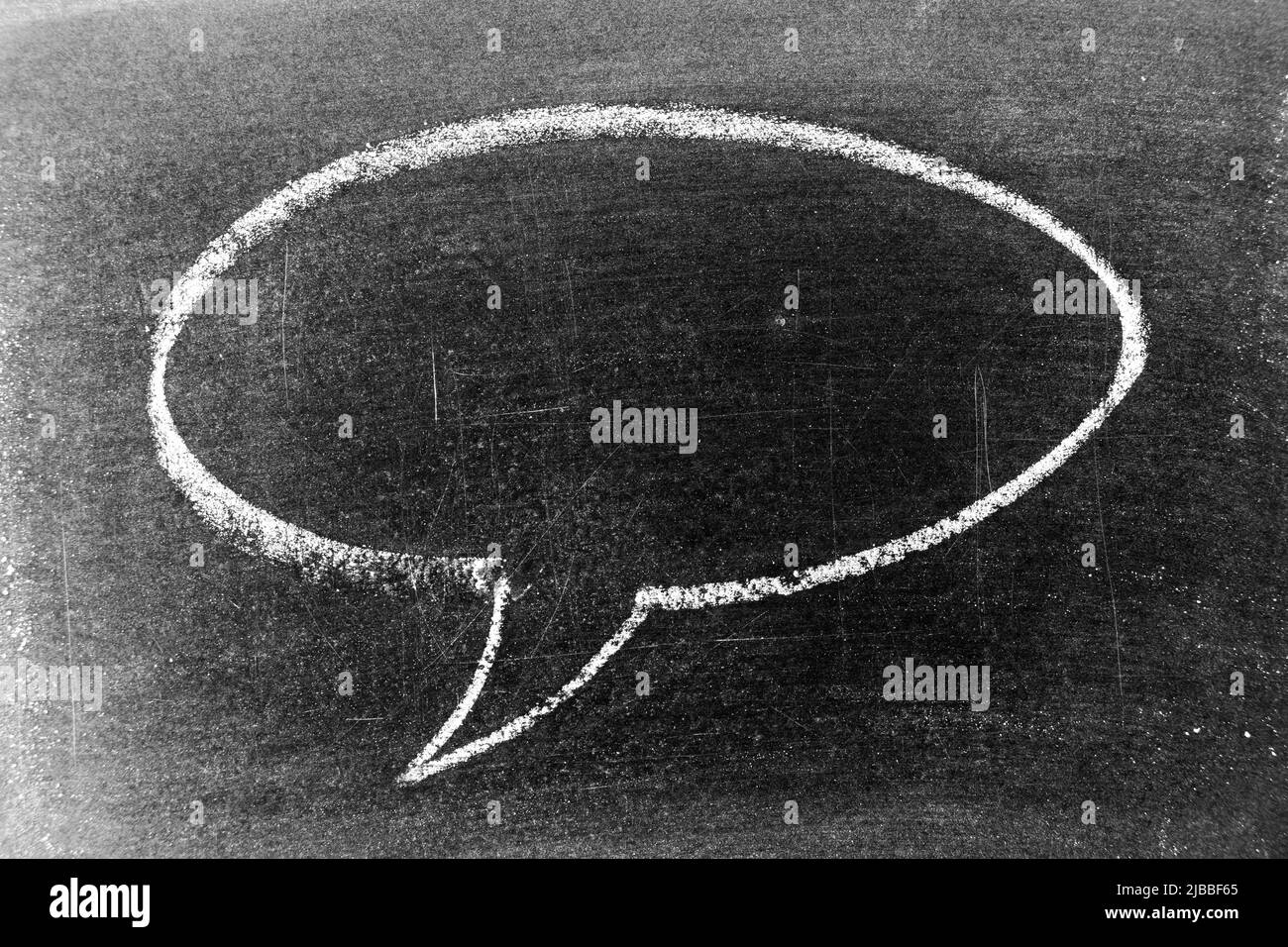 White color chalk hand drawing in round bubble speech shape with blank ...