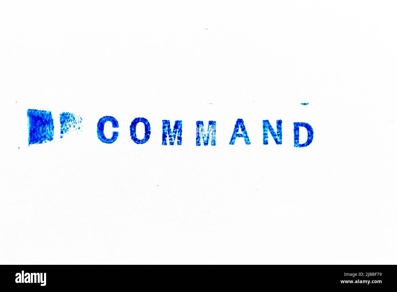 Blue color ink of rubber stamp in word command on white paper ...